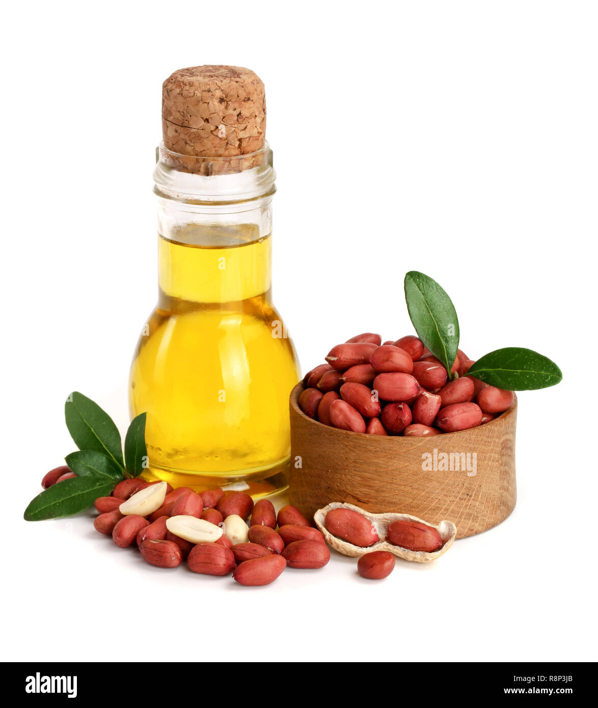 peanut oil in a glass bottle with peanuts in bowl Stock Photo - Alamy