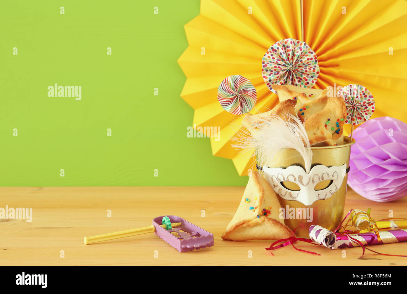 Purim celebration concept (jewish carnival holiday) over wooden table ...