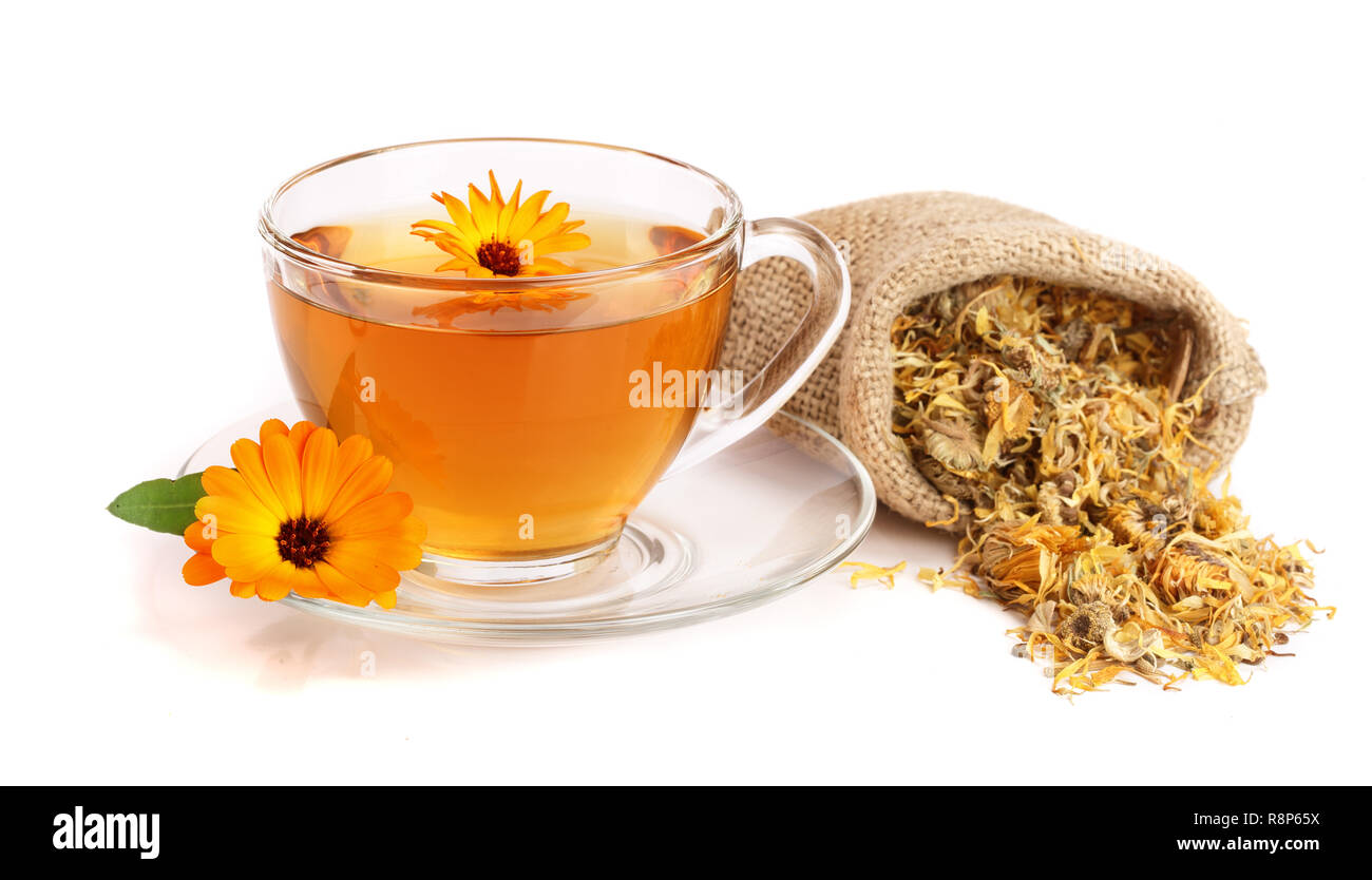 Calendula tea with fresh and dried flowers isolated on white background ...