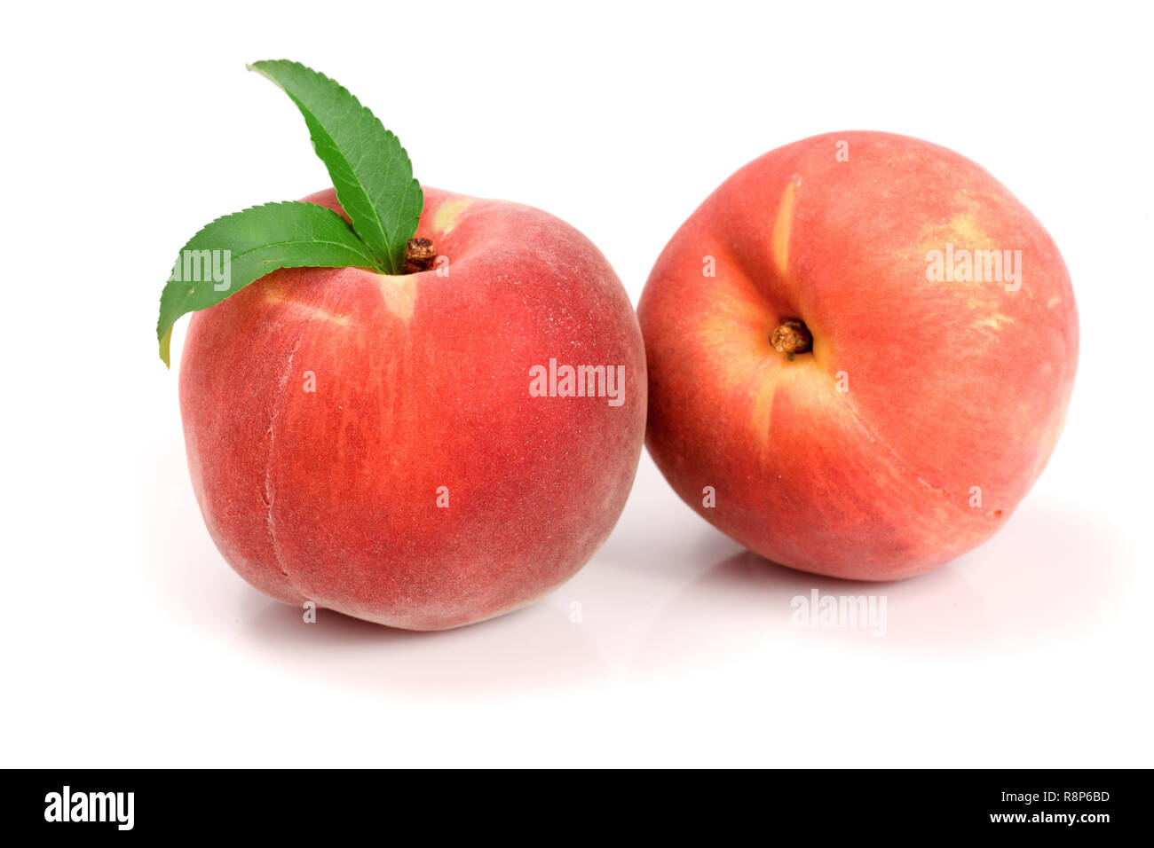 Two peaches with green leaf isolated on white background Stock Photo ...