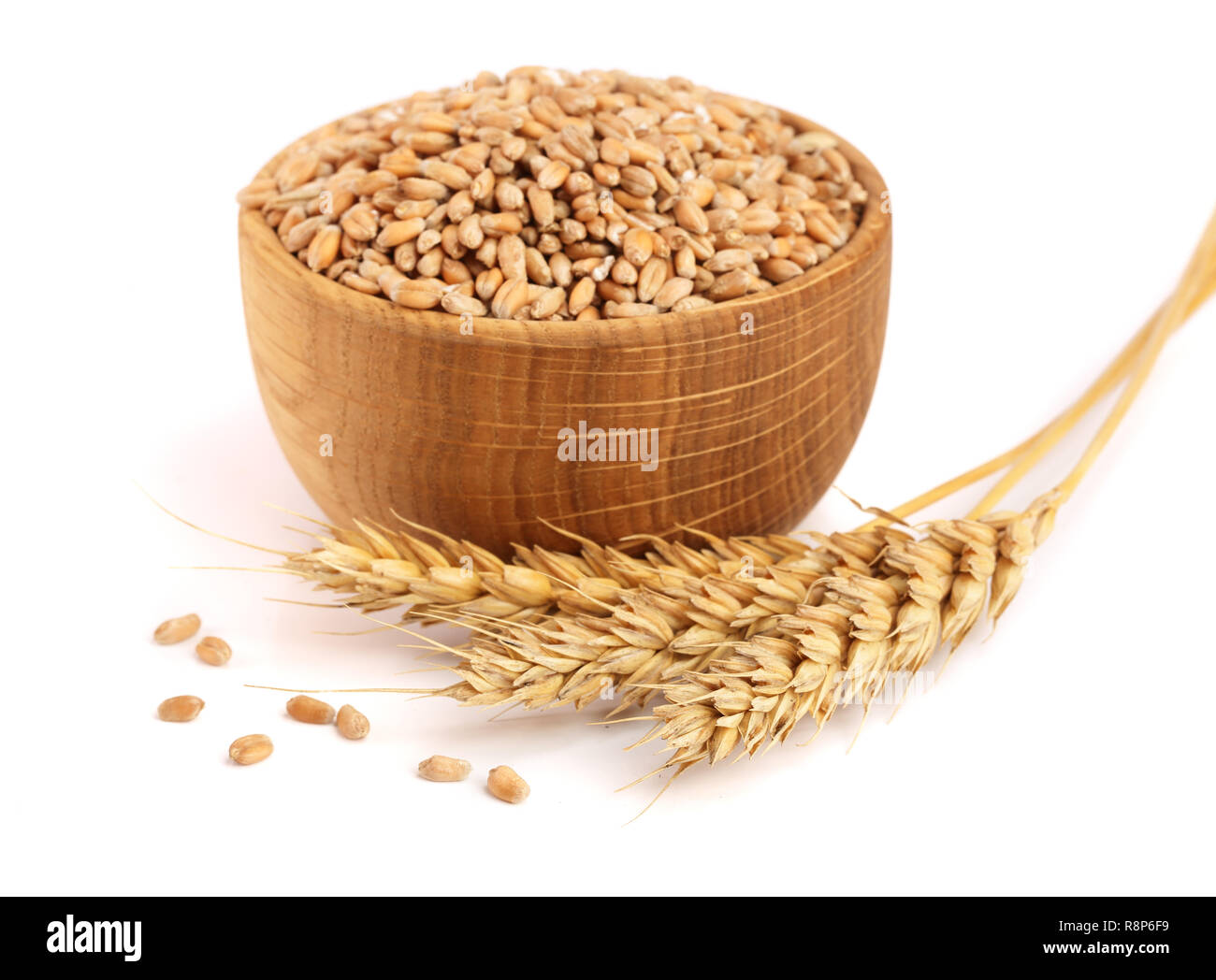 wheat spike and wheat grain in a wooden bowl isolated on white ...