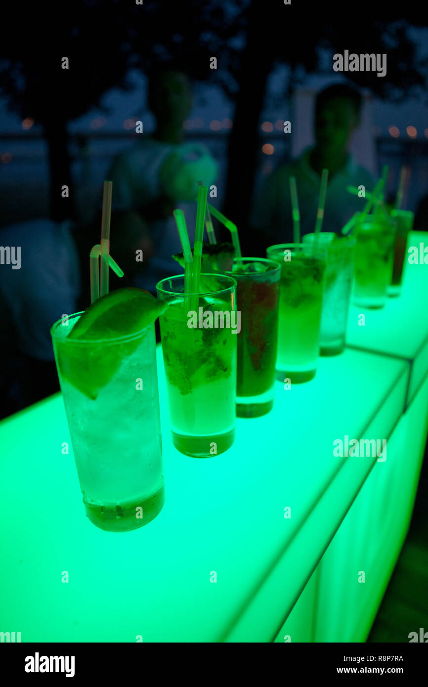 mojito cocktail on the bar at the green glowing bar counter Stock Photo ...