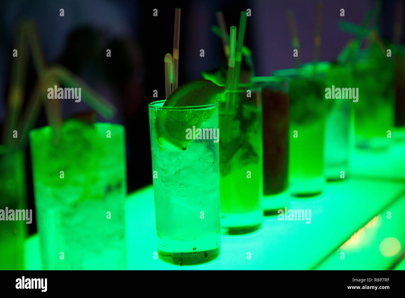 mojito cocktail on the bar at the green glowing bar counter Stock Photo ...