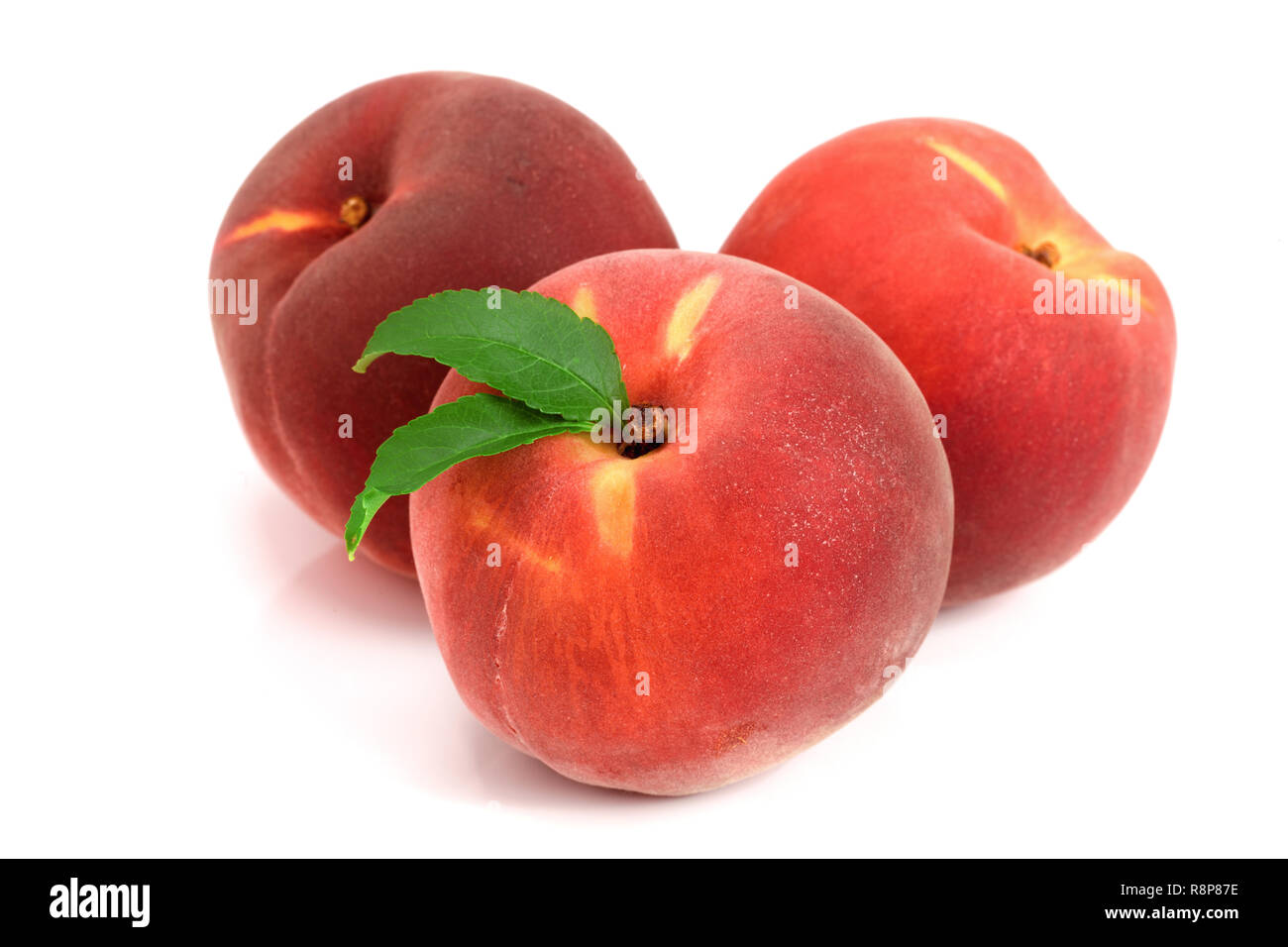 Three peaches with green leaf isolated on white background Stock Photo ...