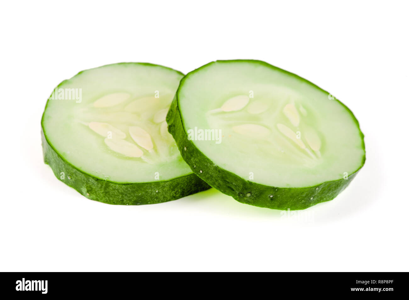Two slices of cucumber isolated on white background Stock Photo - Alamy