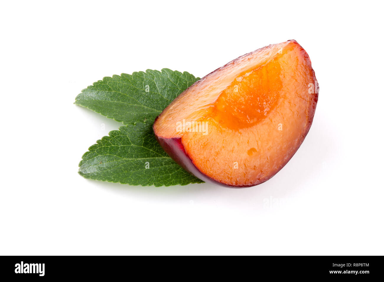 Purple plum slice with leaves isolated on white background Stock Photo ...