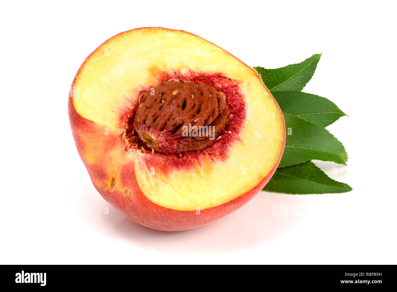 half of peach with green leaf isolated on white background Stock Photo ...