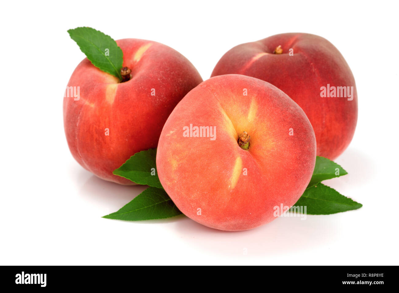 Three peaches with green leaf isolated on white background Stock Photo ...