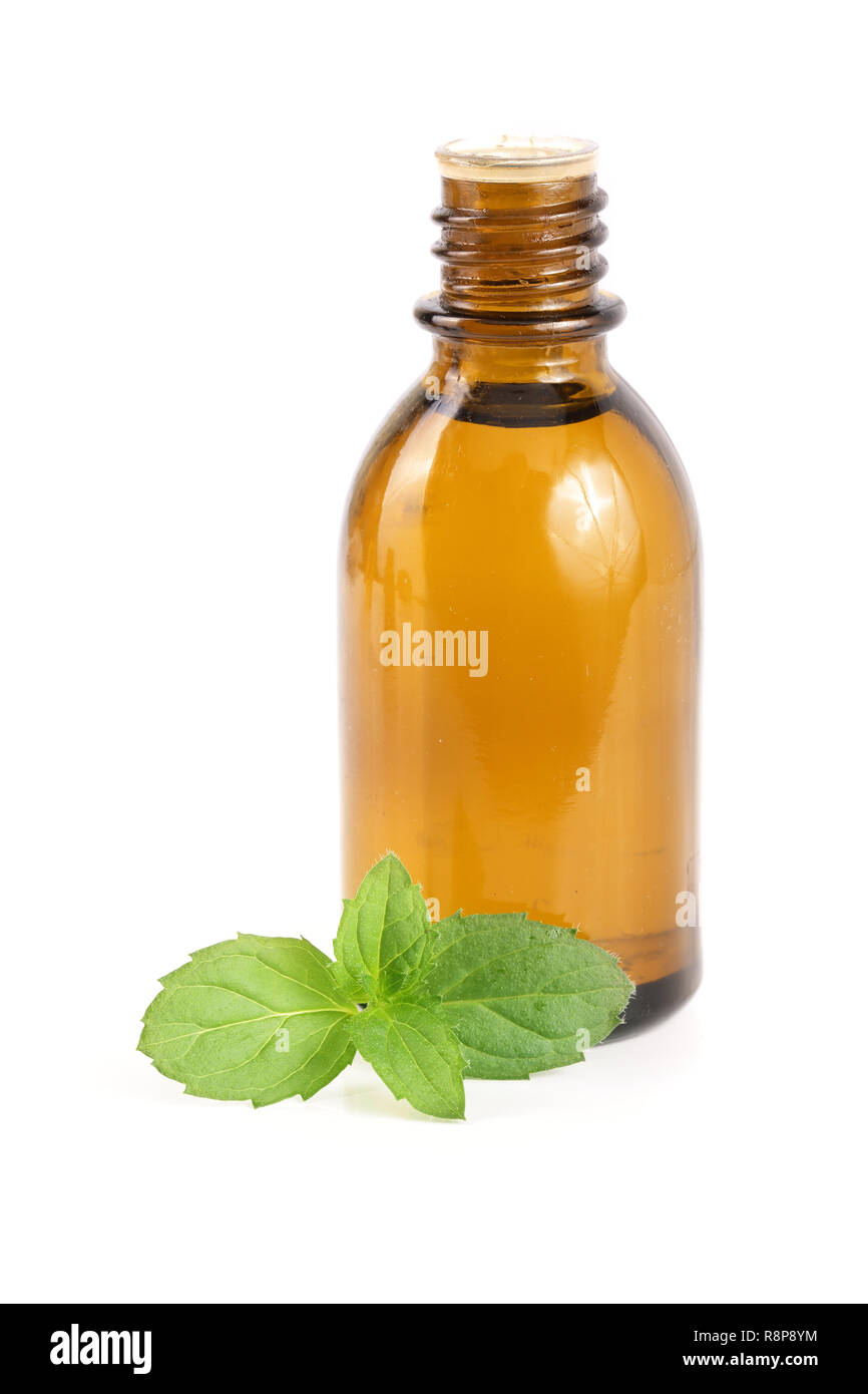 bottle of peppermint oil and fresh mint isolated on white background ...