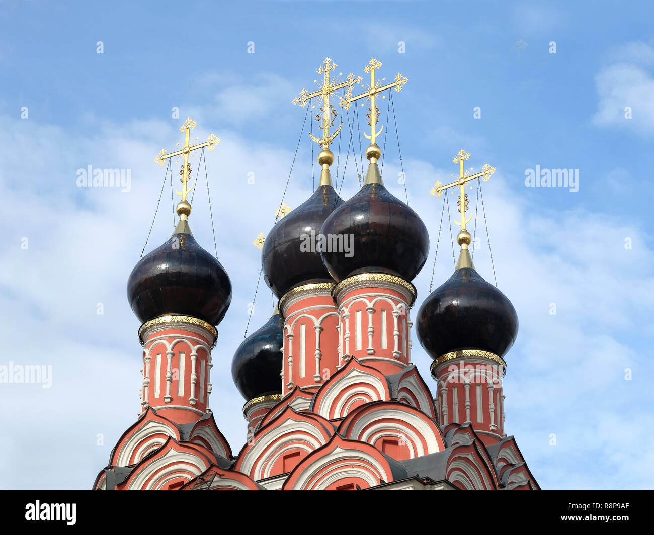 Top of Russian Christian church colored pink with cupolas with golden ...
