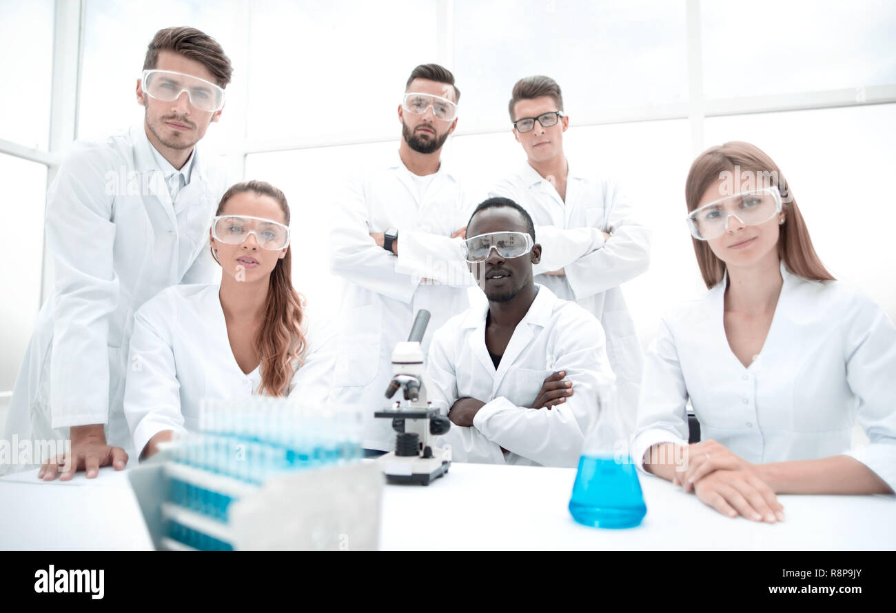Group of young successful scientists posing for camera Stock Photo - Alamy
