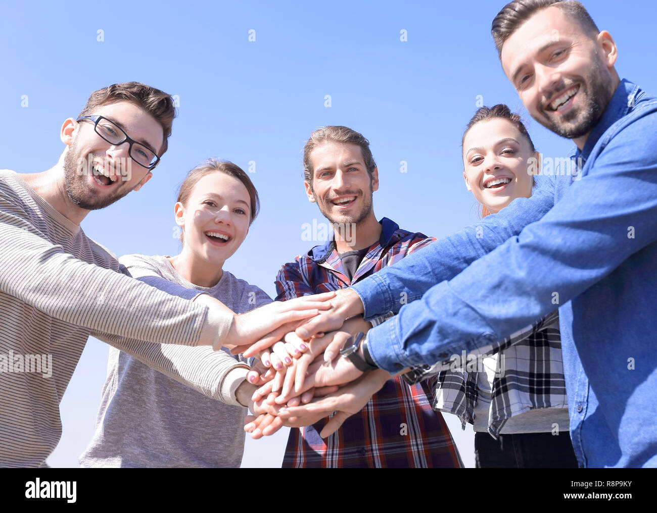 Standing friends joined hands hi-res stock photography and images - Alamy