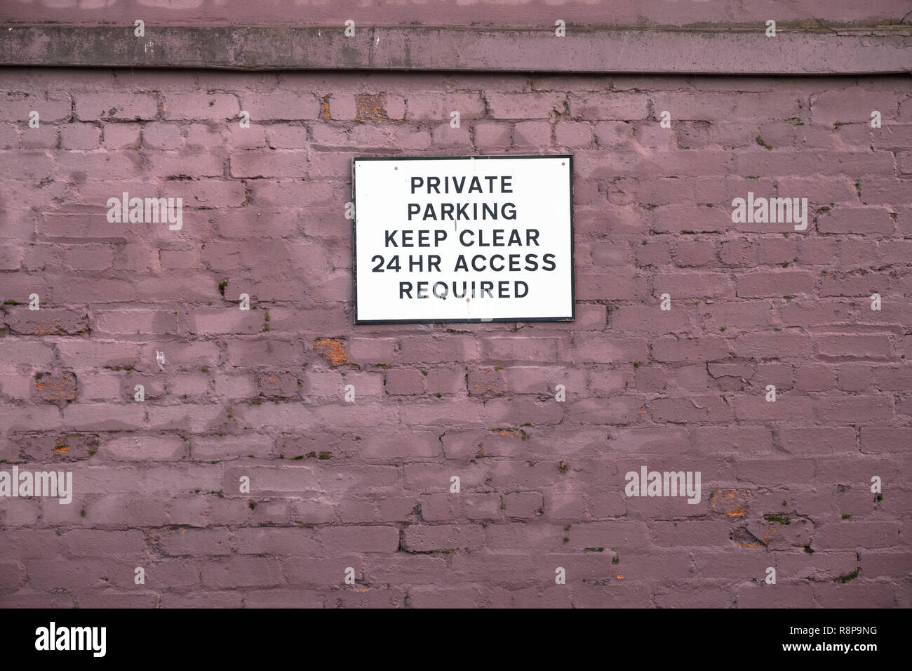 Keep clear 24 access required sign at business entrance roller shutter ...