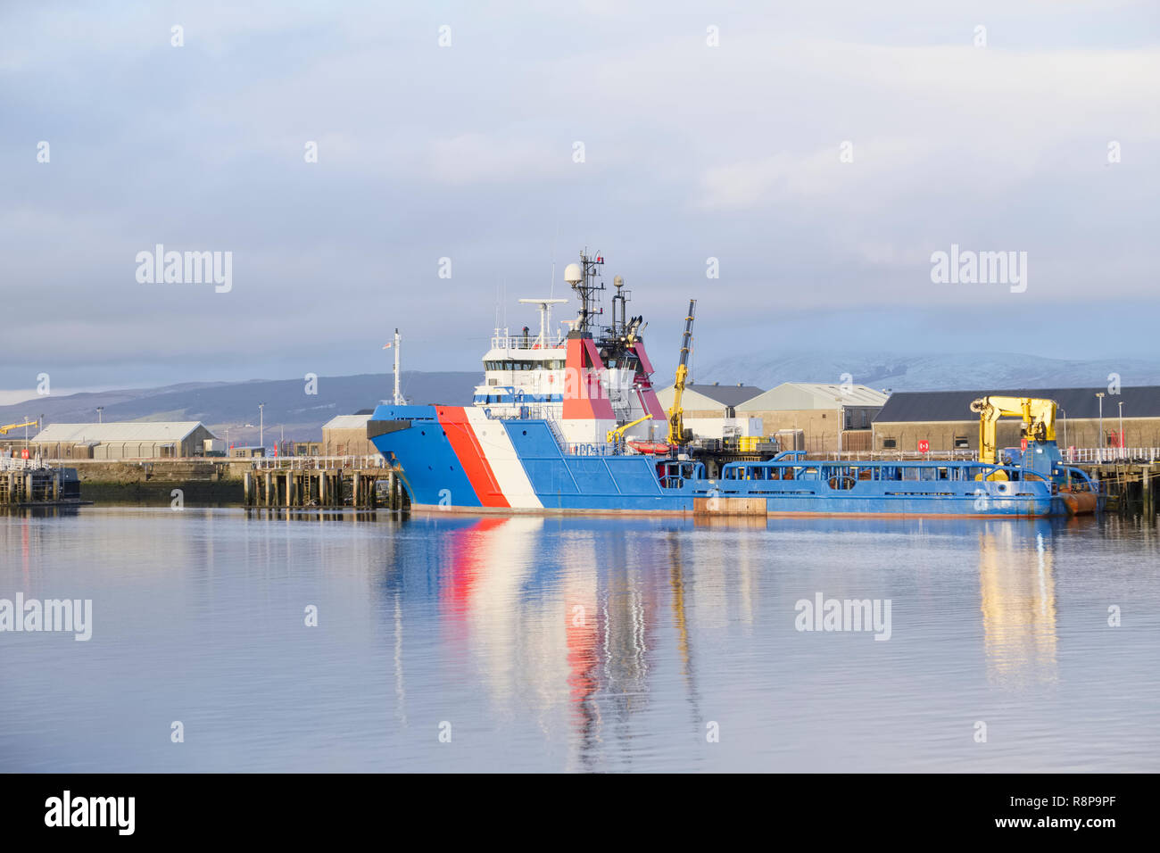 Large Long Ship at Dock with Crane to Lift Cargo Stock Photo - Alamy