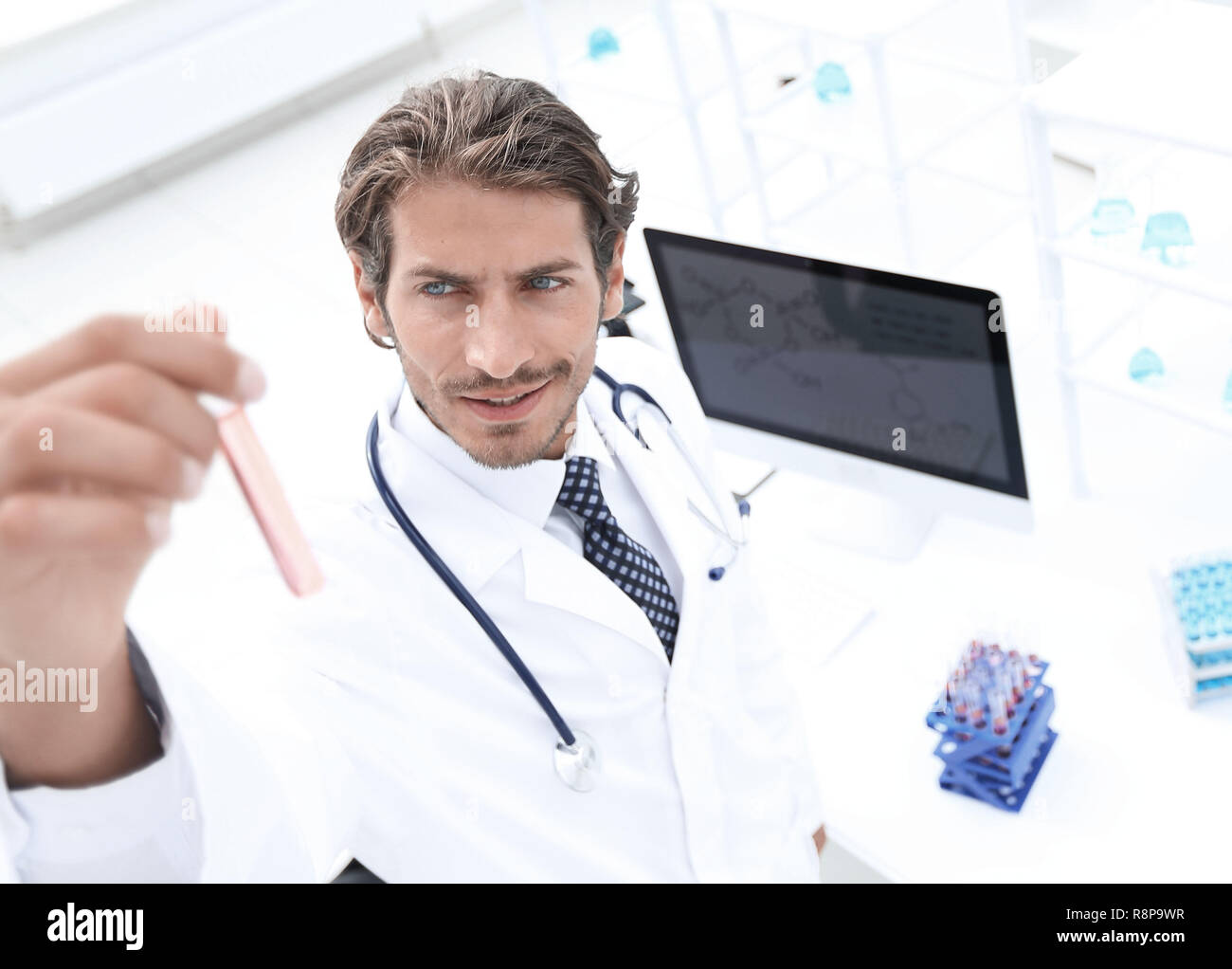 Man in laboratory checking test tubes Stock Photo - Alamy