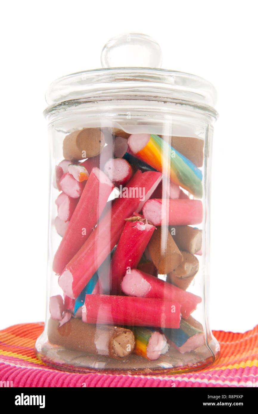 Glass pot of colorful candy canes isolated over white background Stock ...
