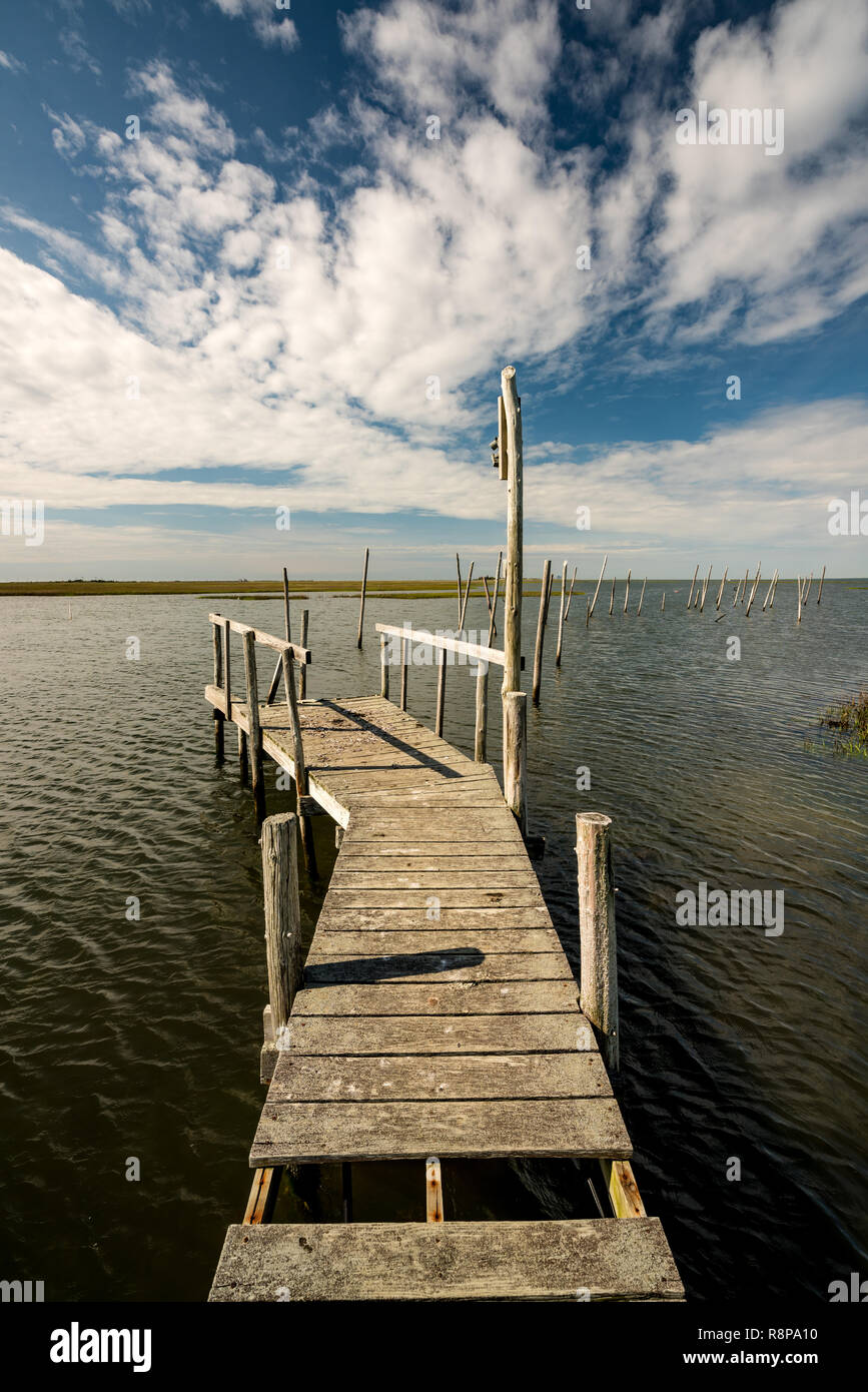 Beautiful day with calm water and cloudy sky with boat dock in the east ...