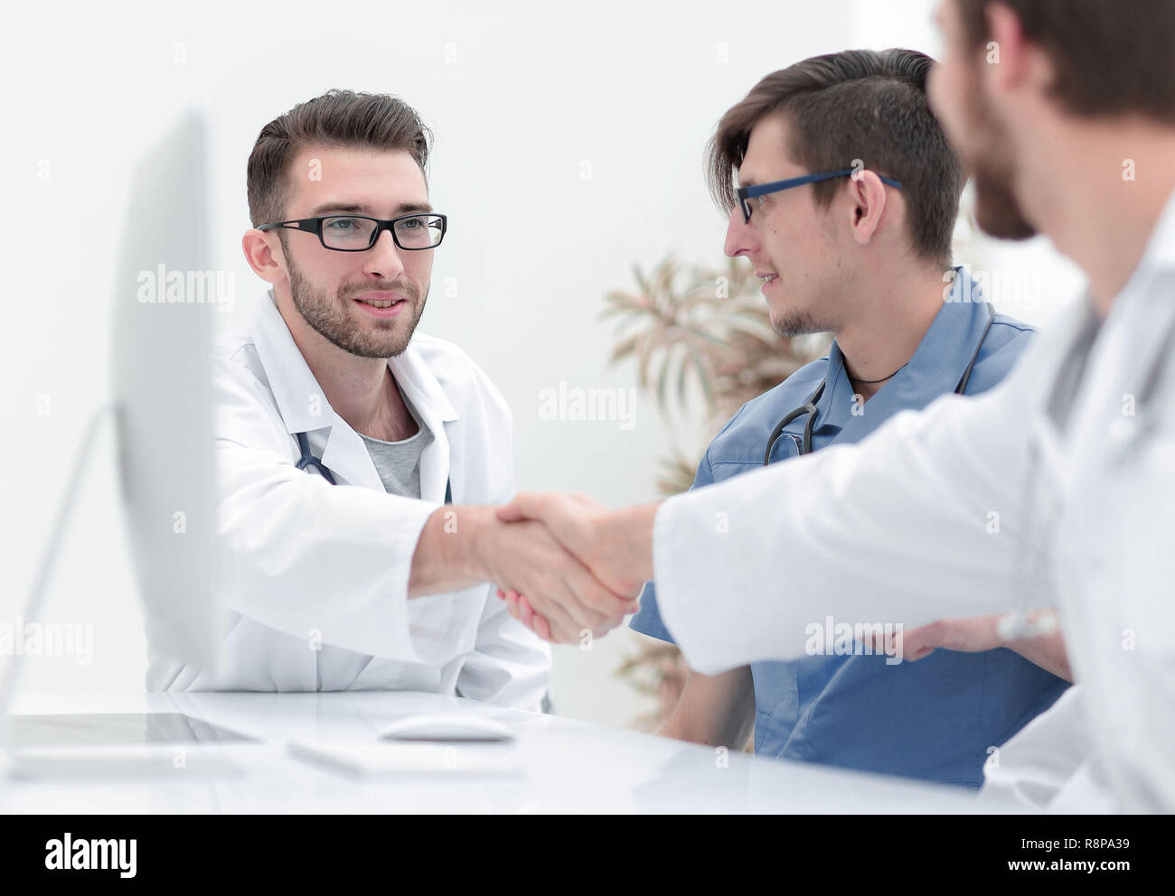 handshake between the two doctors during the working meeting Stock ...