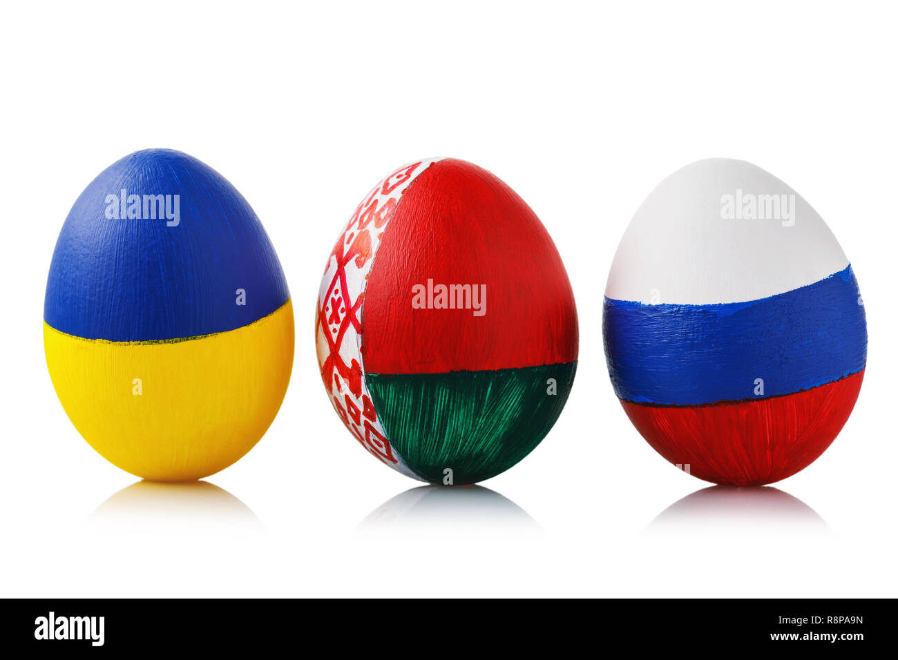 Three Easter eggs painted in colors of the flags of Ukraine, Belarus ...