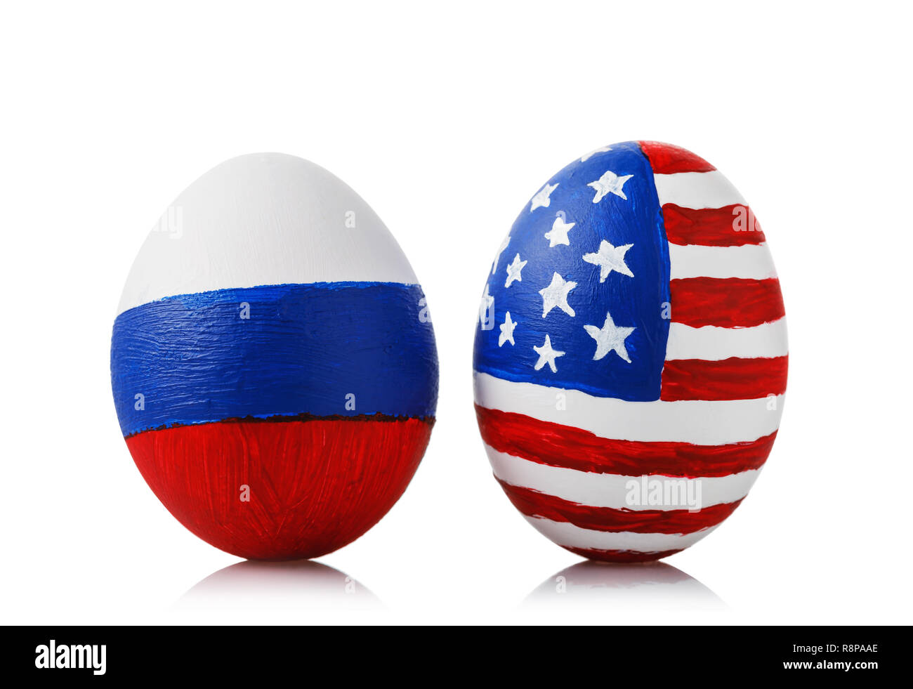 Two Easter eggs painted in colors of the flags of Russia and America ...