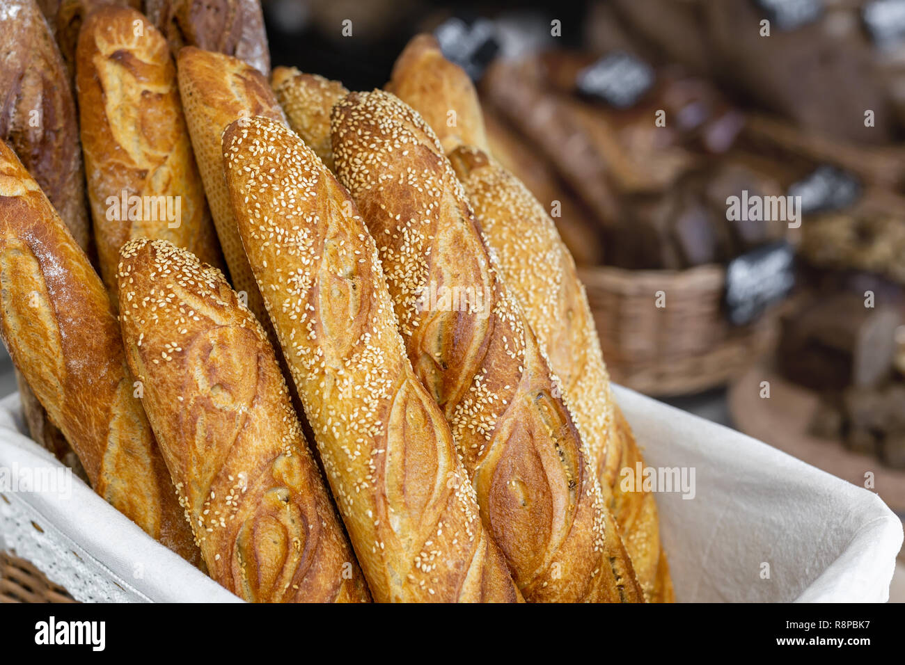 Traditional crusty French bread baguette in basket at bakery. Fresh ...