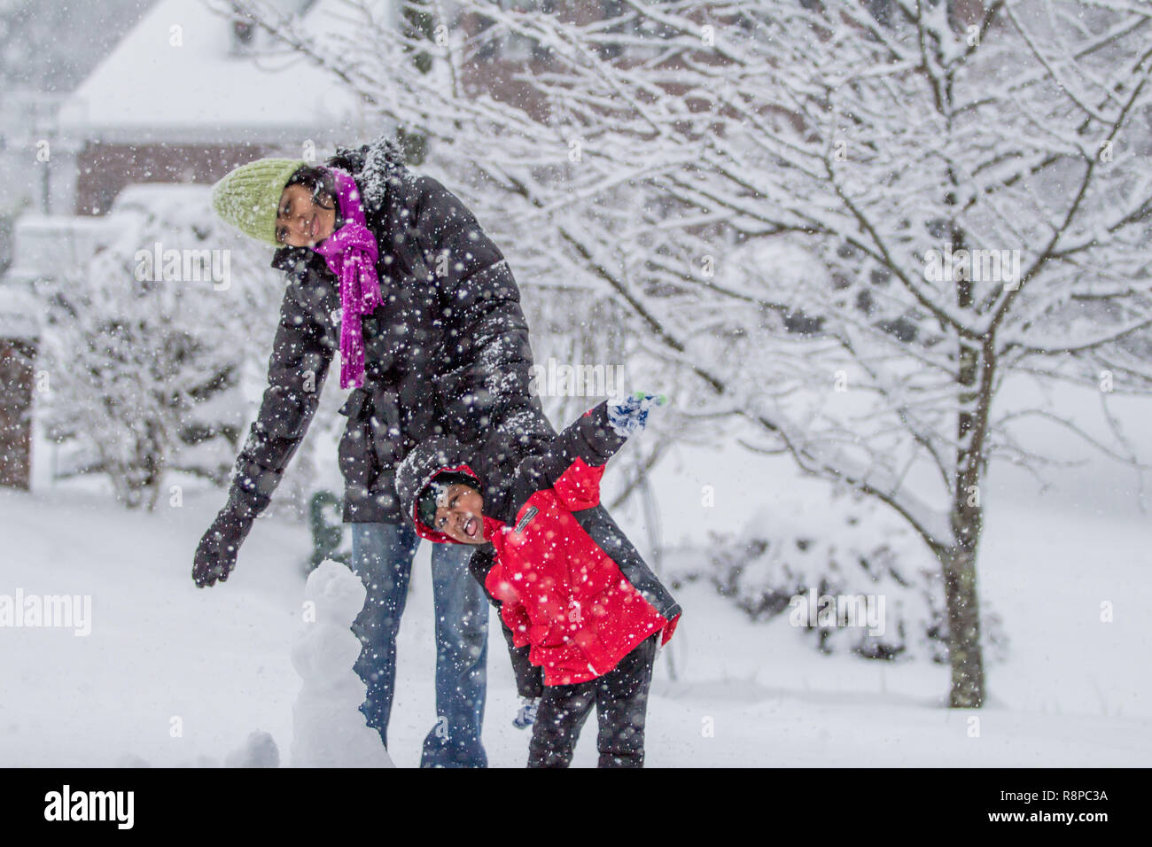 Mother and son playing in the snow Stock Photo - Alamy
