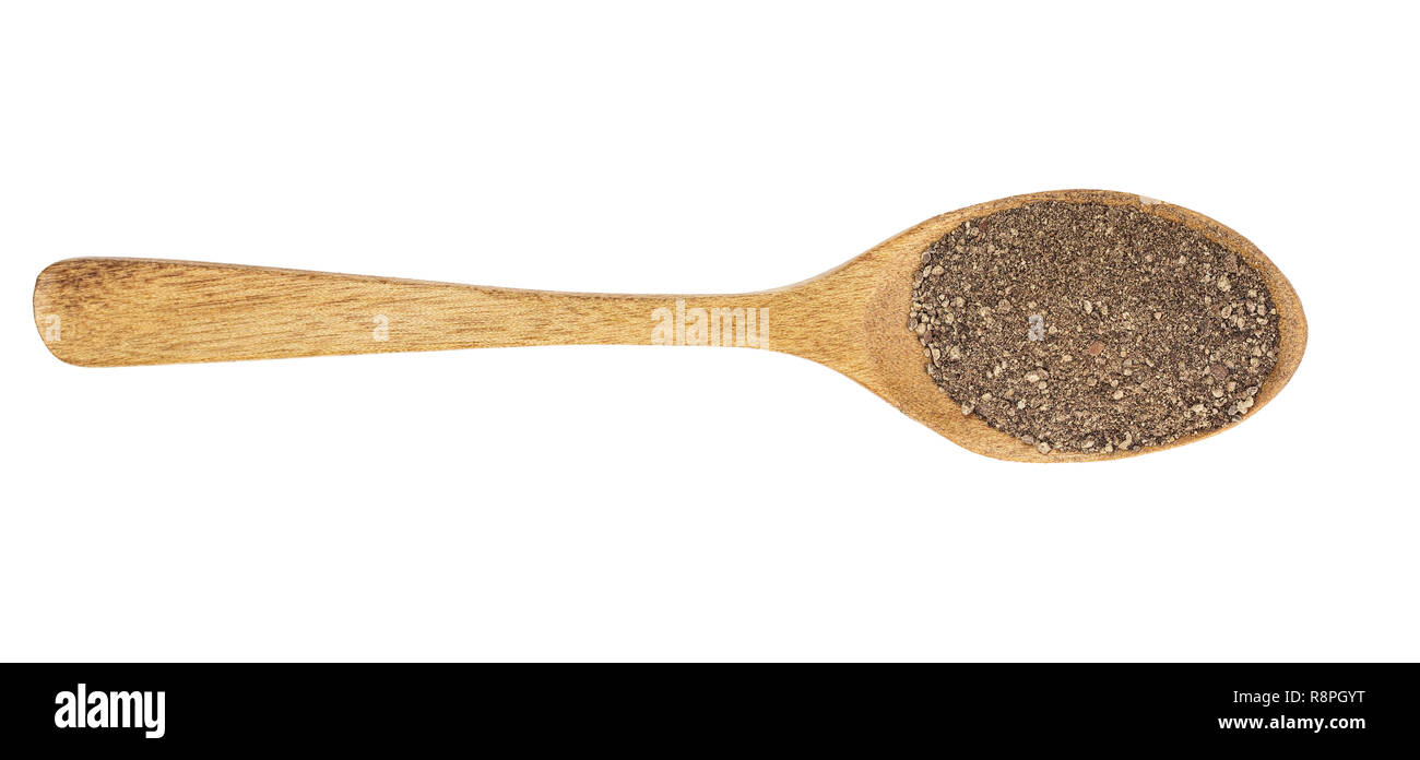 Ground black pepper in wooden spoon isolated on white background. Top ...