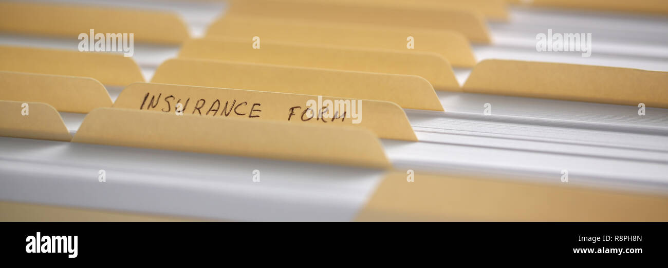 Yellow folders with labels and paper in a row Stock Photo - Alamy