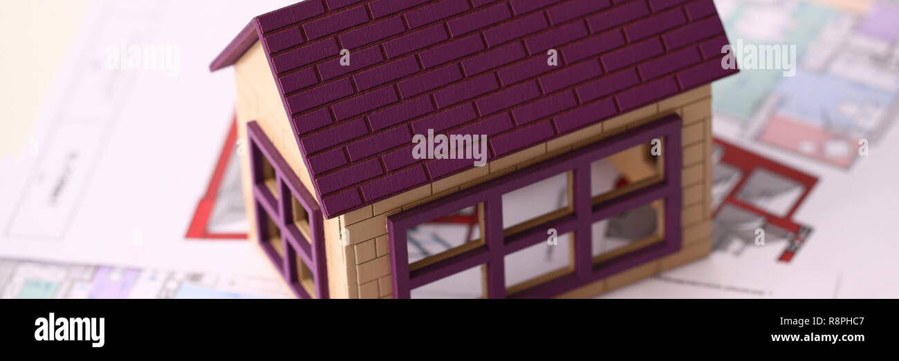 Small miniature house stands on drawing Stock Photo - Alamy
