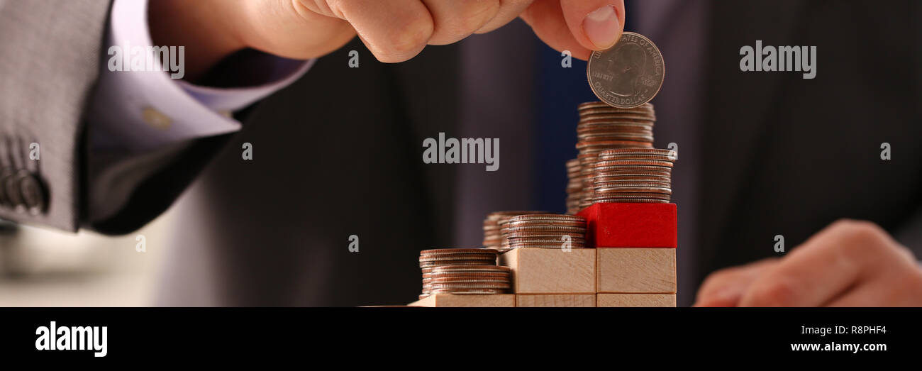 Hand businessman putting pin money Stock Photo - Alamy