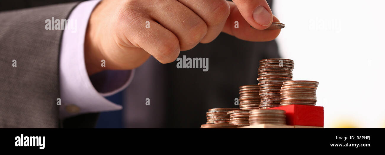 Hand businessman putting pin money Stock Photo - Alamy