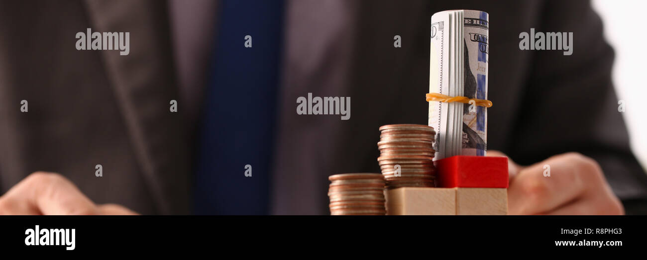 Hand businessman putting pin money Stock Photo - Alamy