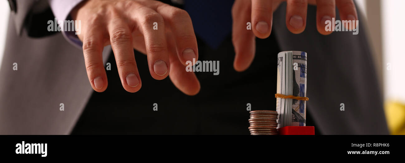 Male arm in suit reach for money closeup Stock Photo - Alamy