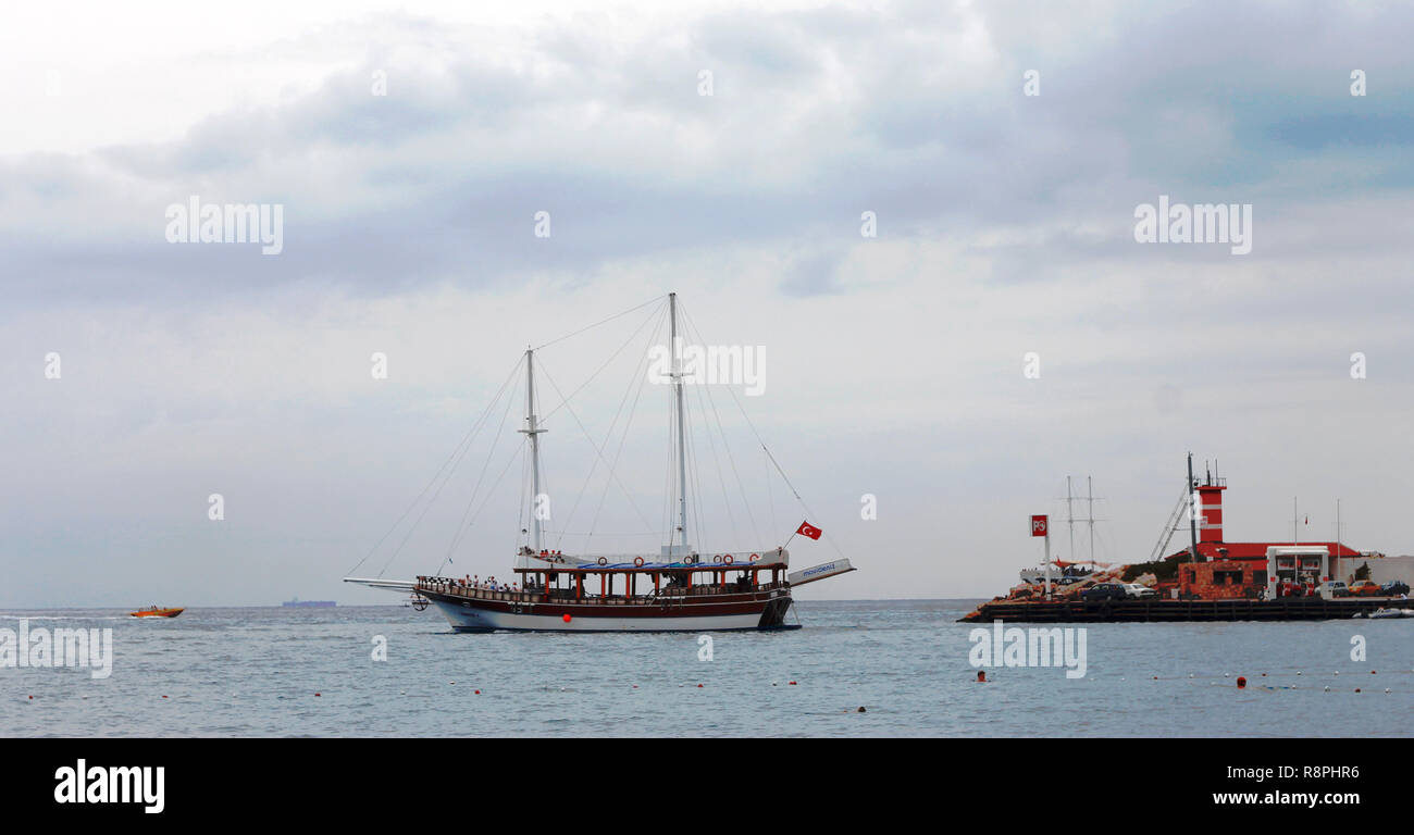 Sail ship moving away from the shore Stock Photo - Alamy