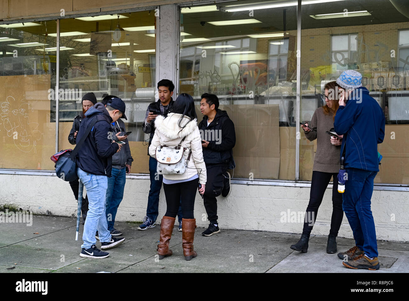 Young people all using cellphones Stock Photo - Alamy