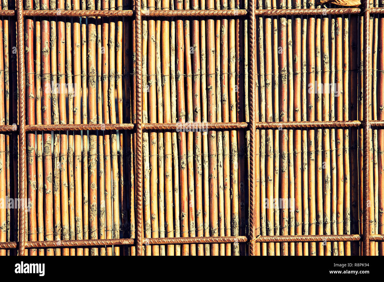 sunny bamboo wall with iron grate in square shape Stock Photo - Alamy