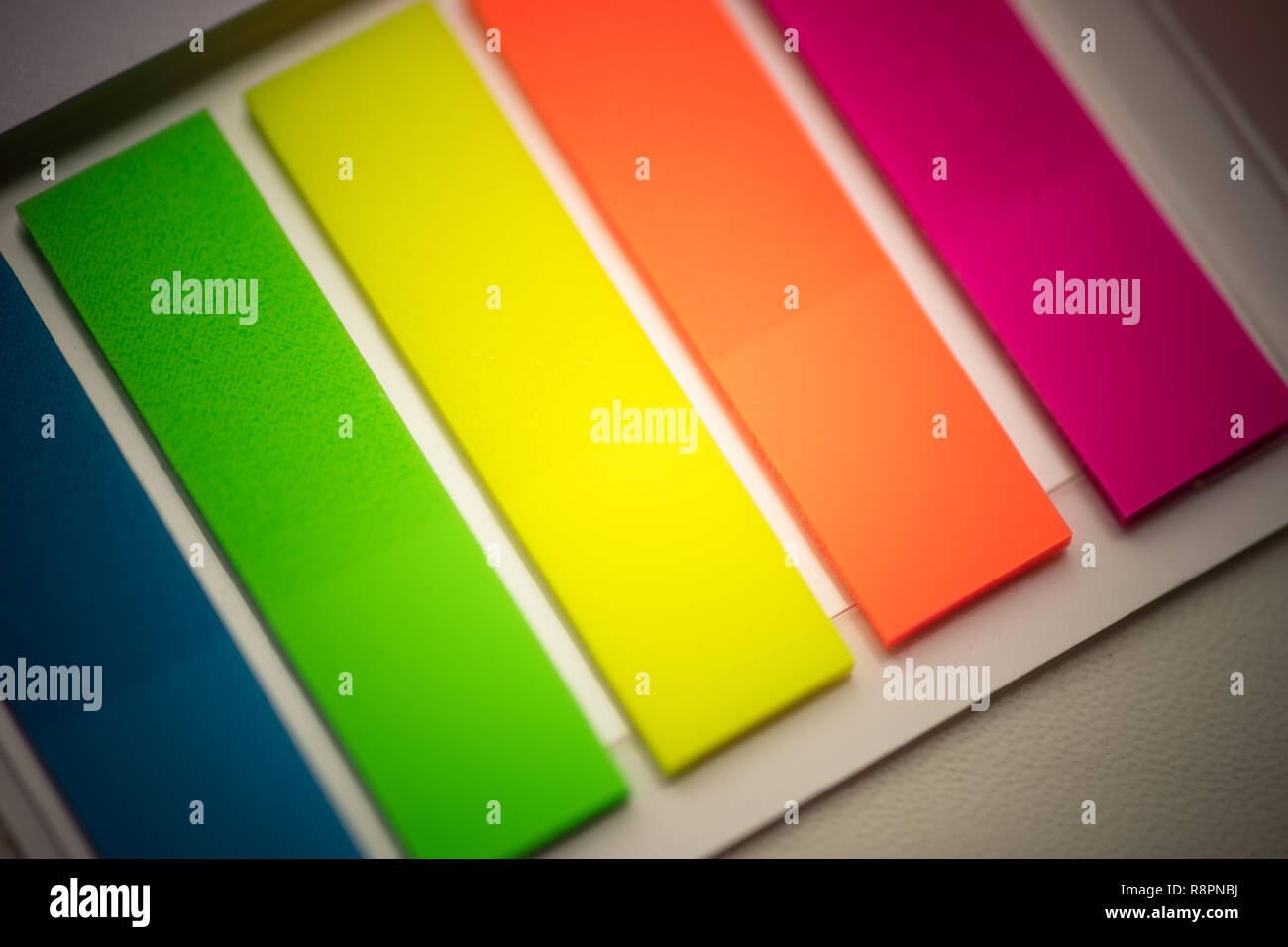 blurred background multicolored notes in a notebook with a white ...