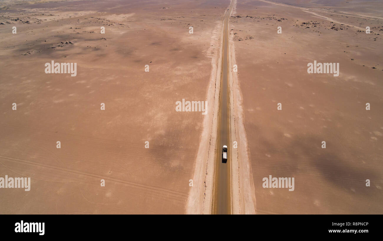 Aerial view from above to lonely Atacama desert route, with a truck ...