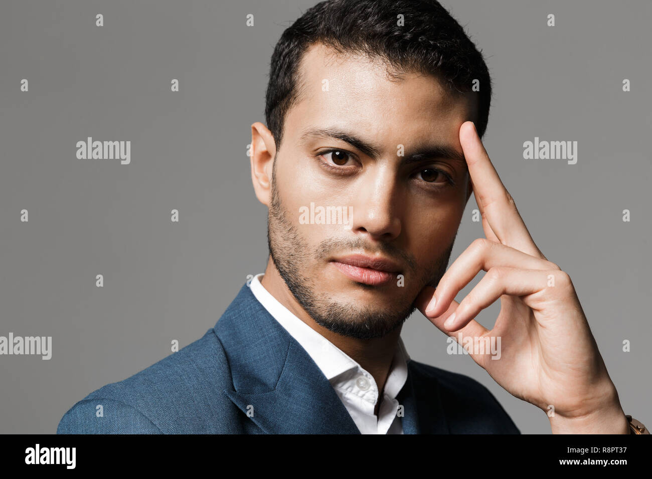 Image of concentrated arabic businessman 30s in formal suit thinking ...