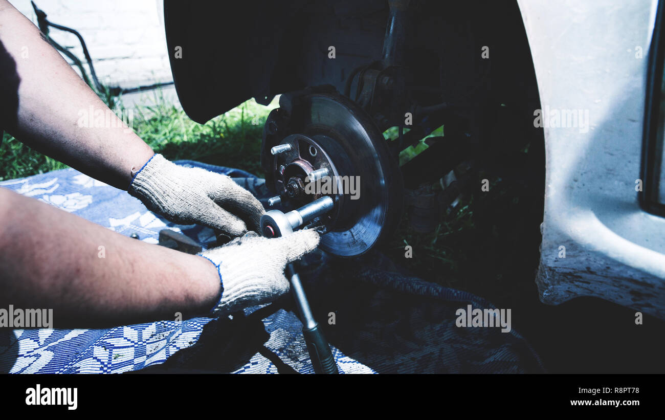 The car repairs. Changing a wheel.driver changes the wheel on the car ...