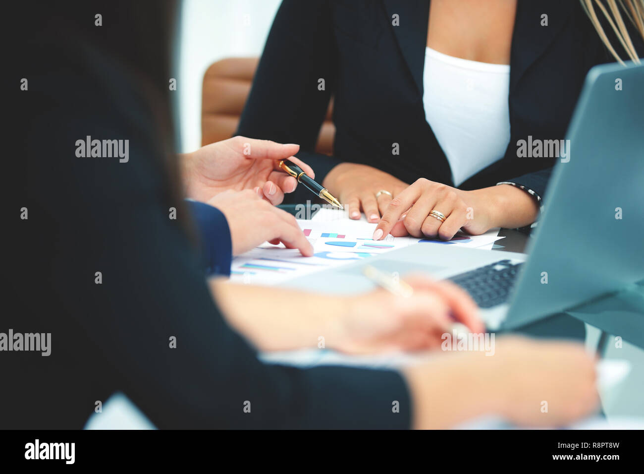 group of economists working with financial charts Stock Photo - Alamy
