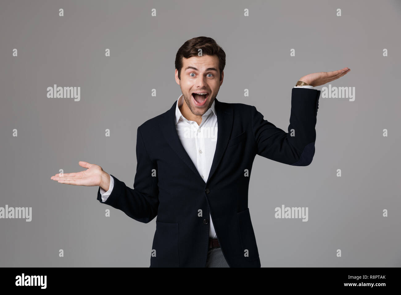 Image of surprised businessman 30s in formal suit screaming and ...