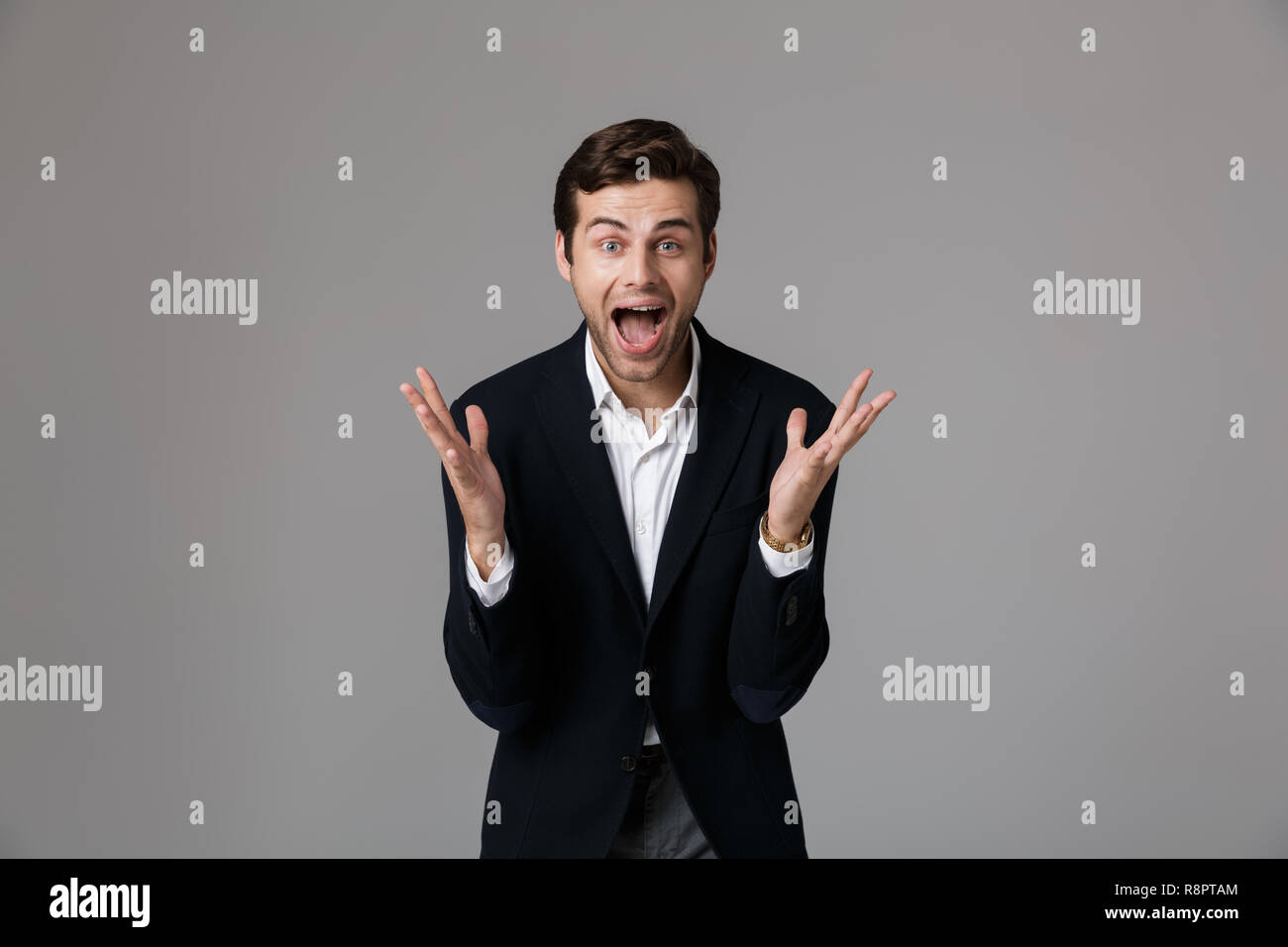 Image of emotional businessman 30s in formal suit screaming and ...