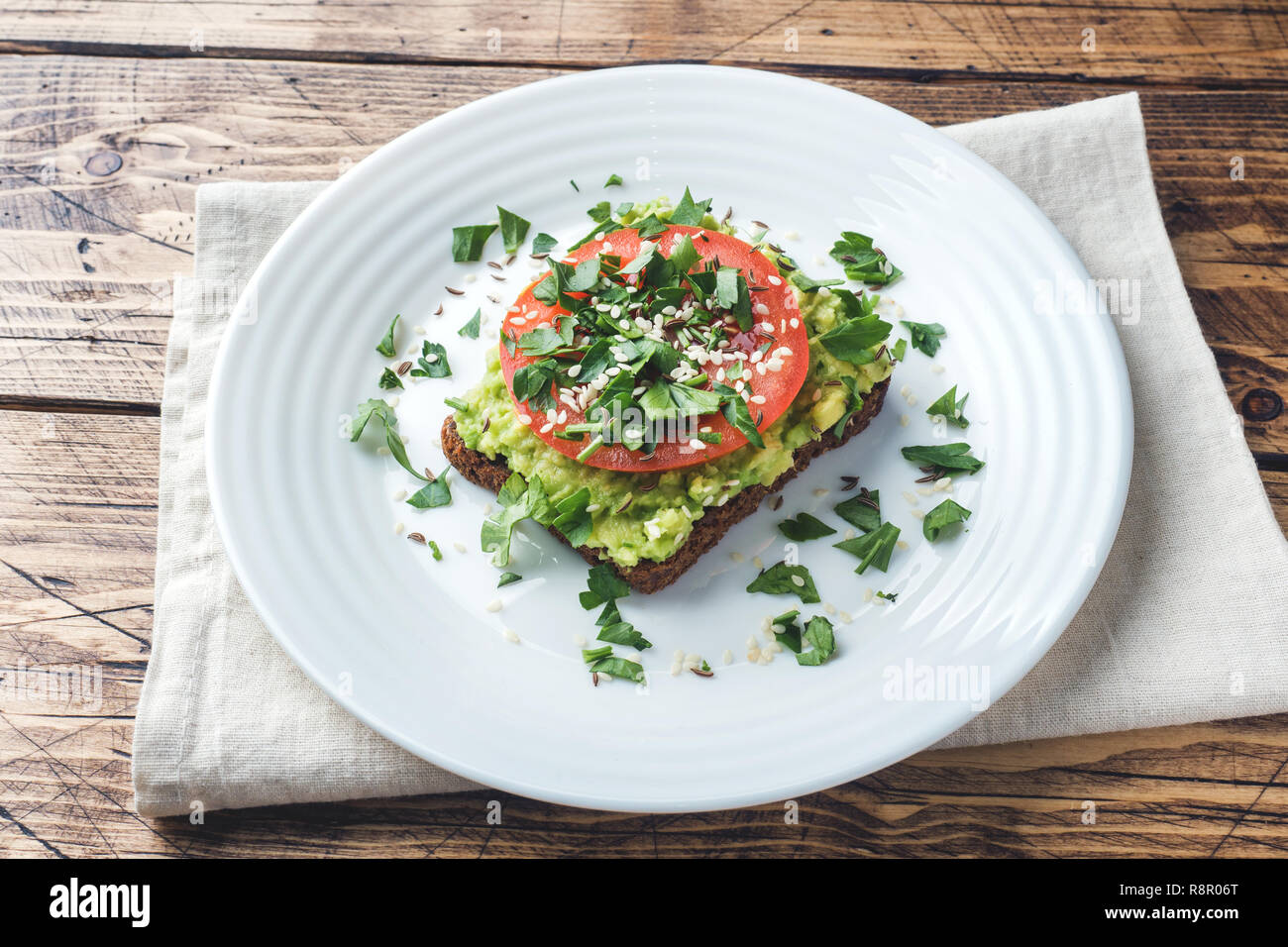 Avocado toast. Healthy toast with avocado mash and tomatoes on a plate ...