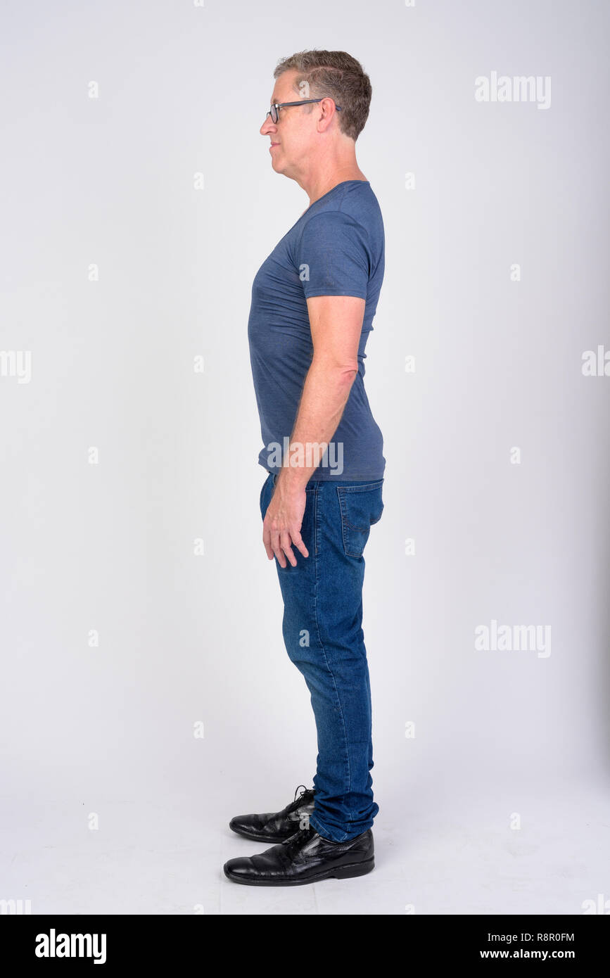 Full body shot profile view of mature man against white background ...