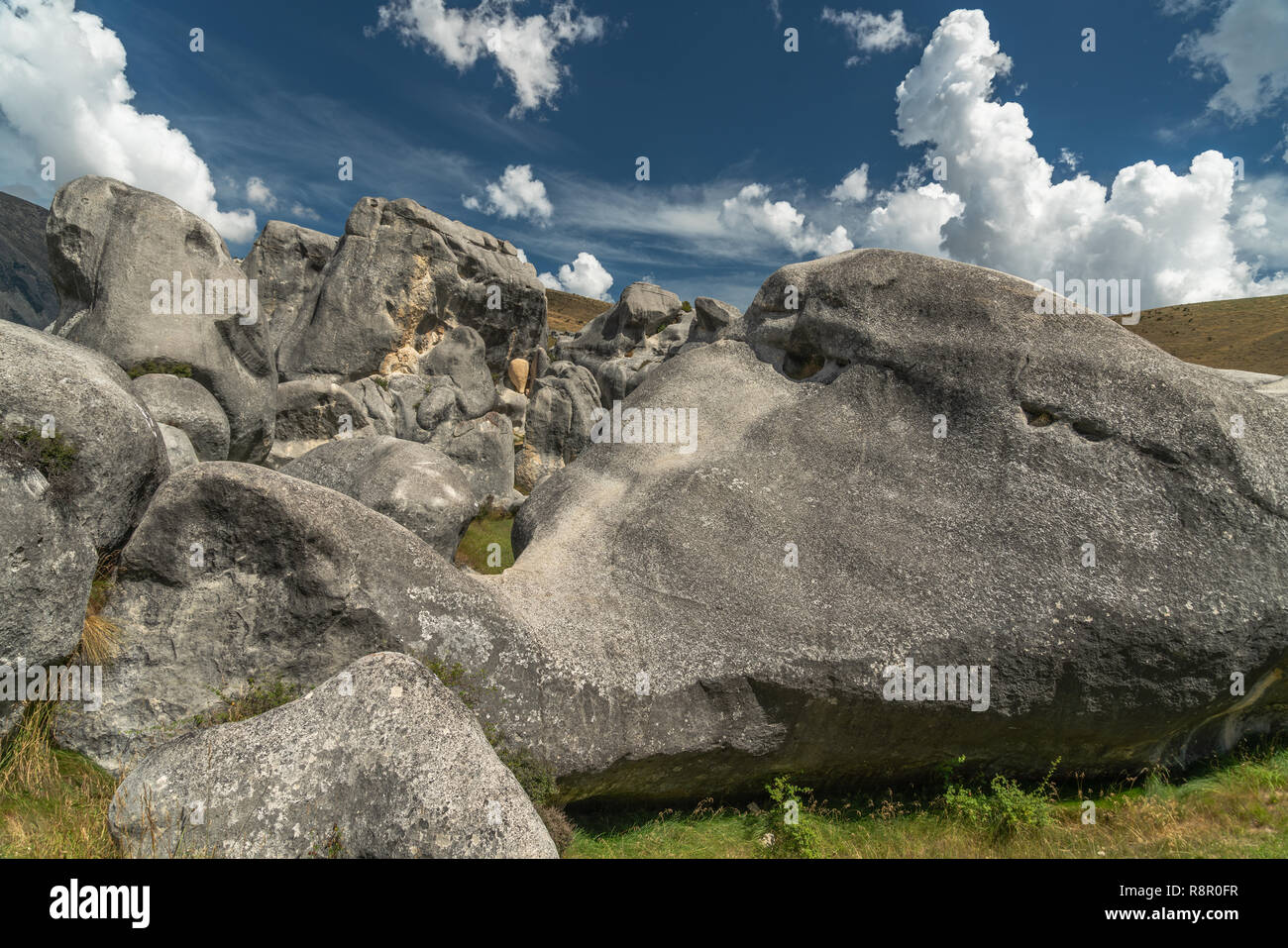 Giant limestone boulders and dramatic cloudy sky in Castle Hill, South ...