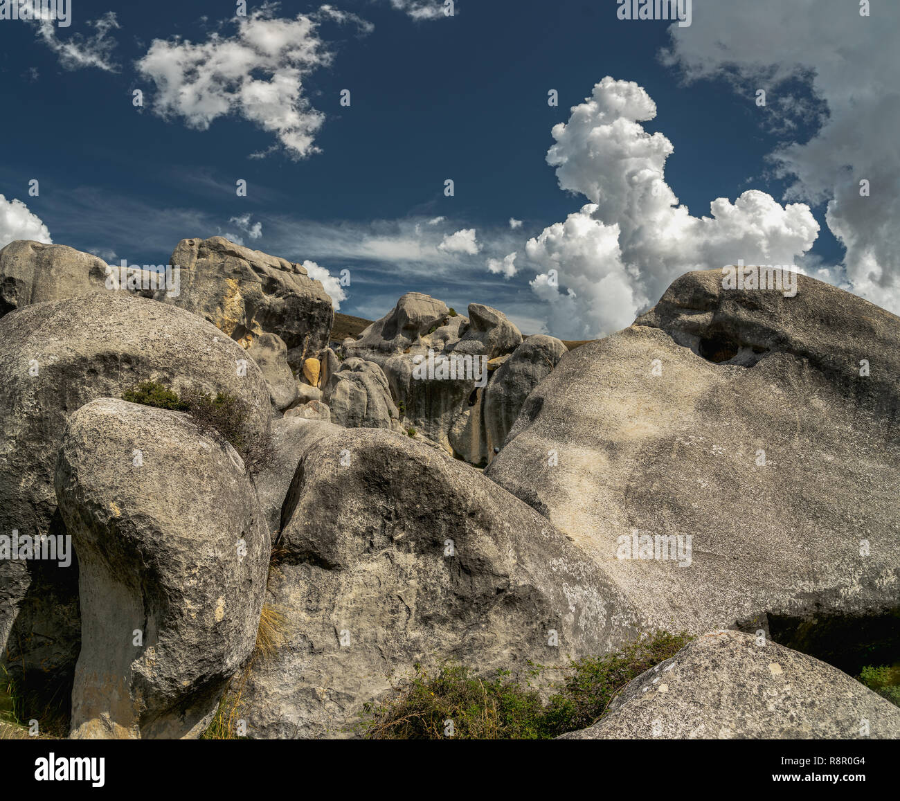 Giant limestone boulders and dramatic cloudy sky in Castle Hill, South ...