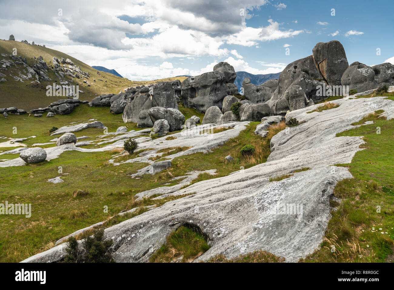 Giant limestone boulders and dramatic cloudy sky in Castle Hill, South ...