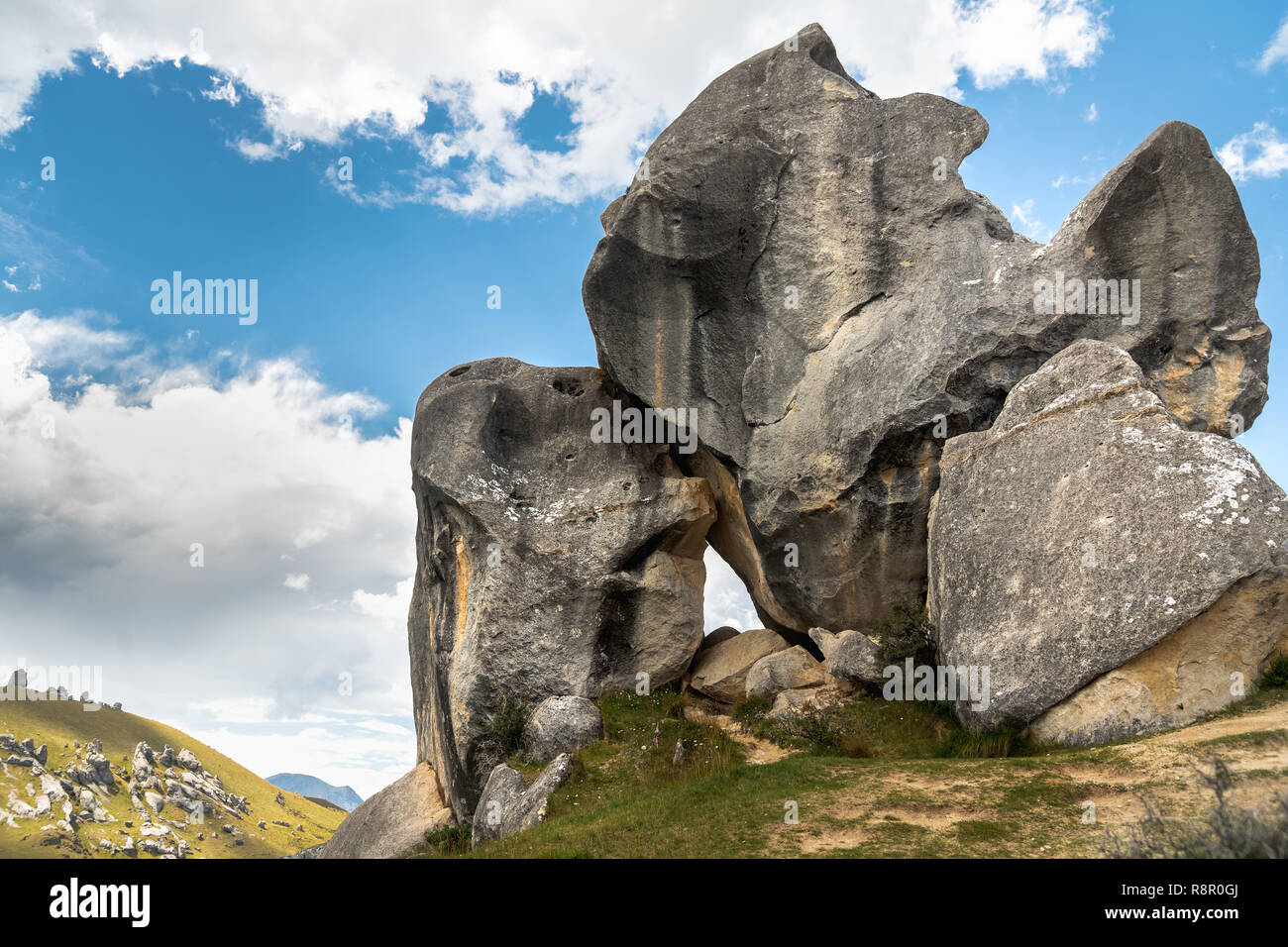 Giant limestone boulders and dramatic cloudy sky in Castle Hill, South ...