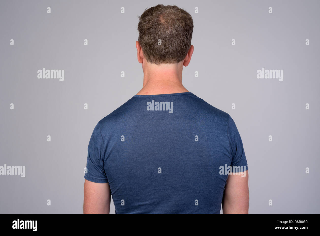 Rear view of mature man against white background Stock Photo - Alamy